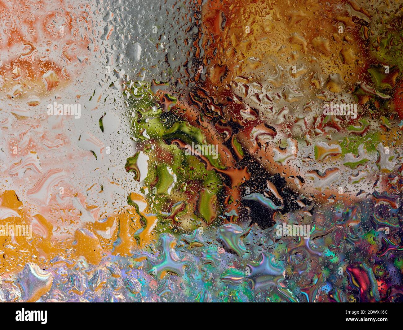 Water droplet patterns on hard surface with colourful background Stock ...