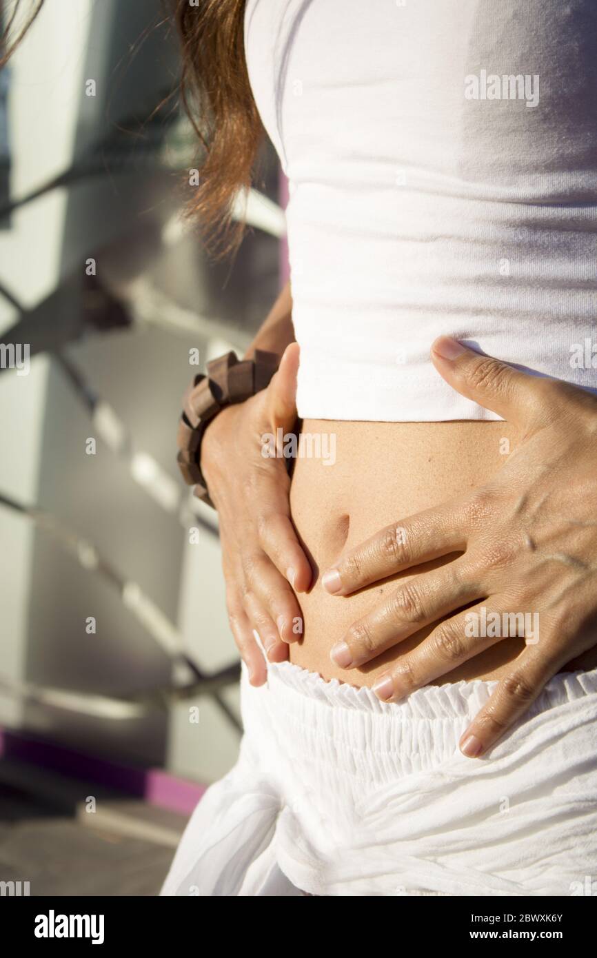 Flat stomach of woman health symptom on hands Stock Photo - Alamy