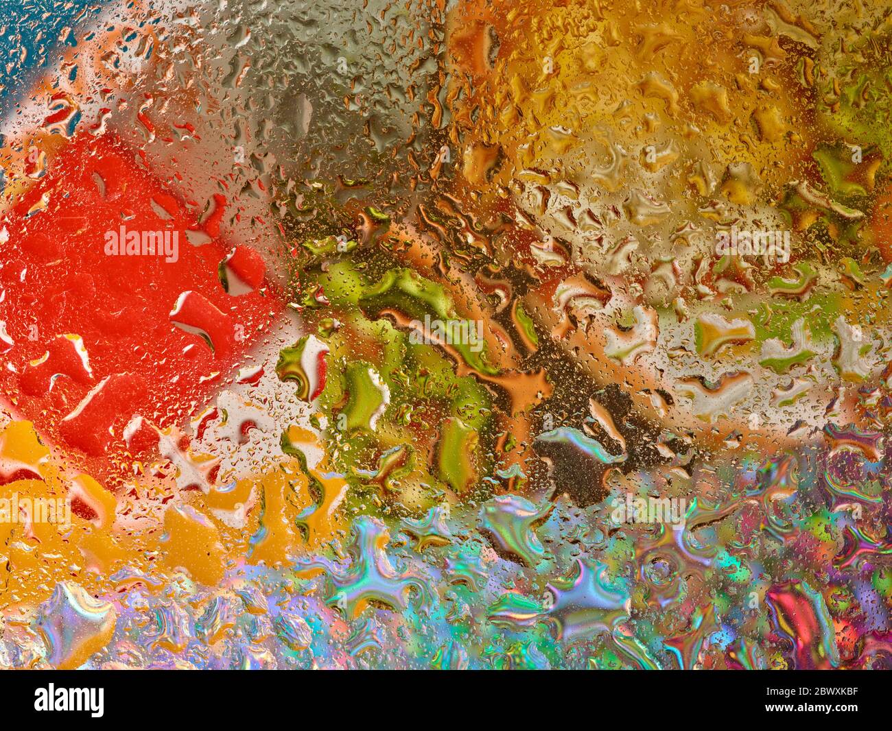 Water drop (drops and droplets) on hard surface with colourful ...