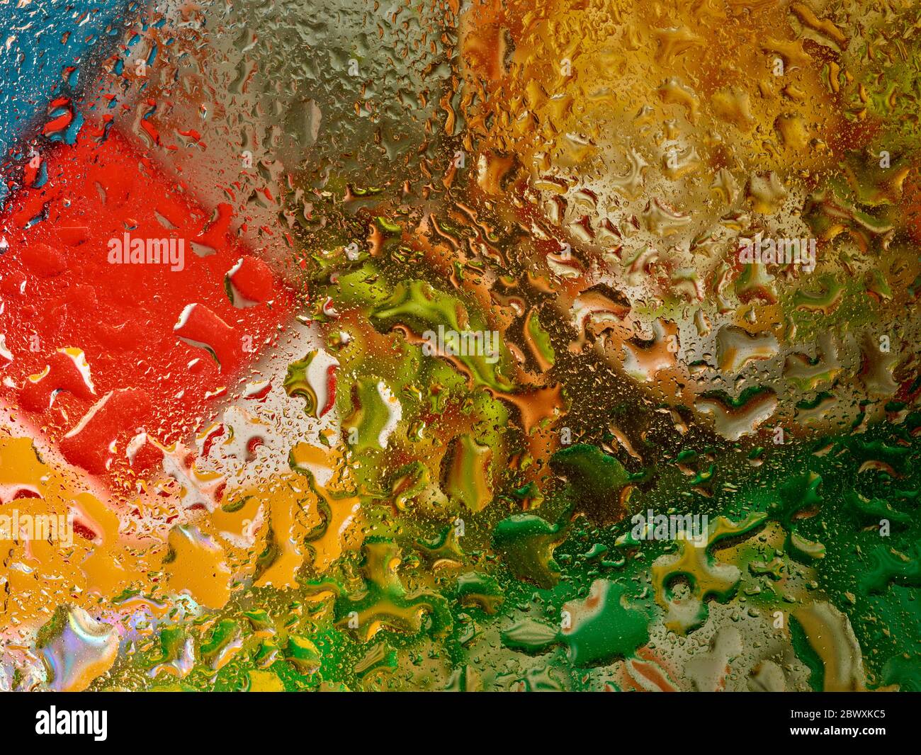 Water drop (drops and droplets) on hard surface with colourful ...