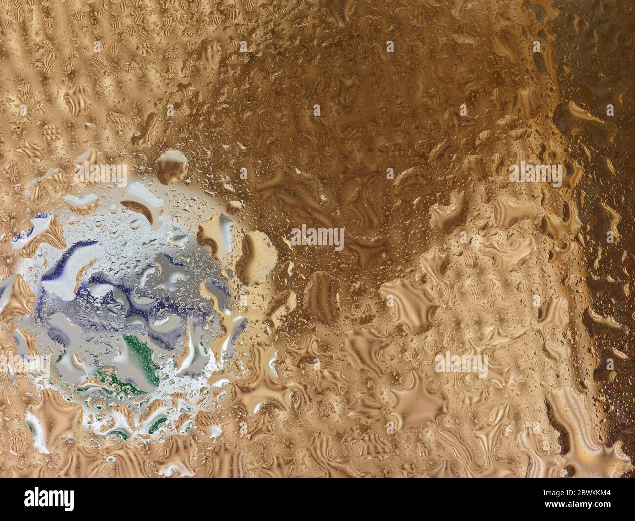 Water drop (drops and droplets) on hard surface with colourful ...