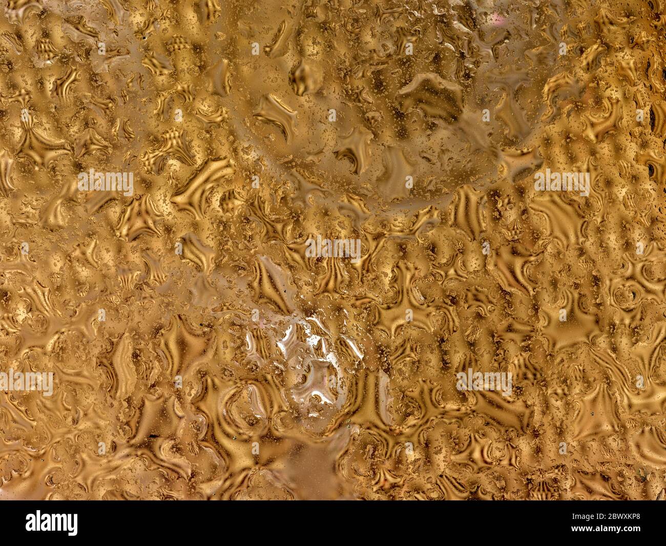 Water drop (drops and droplets) on hard surface with colourful ...