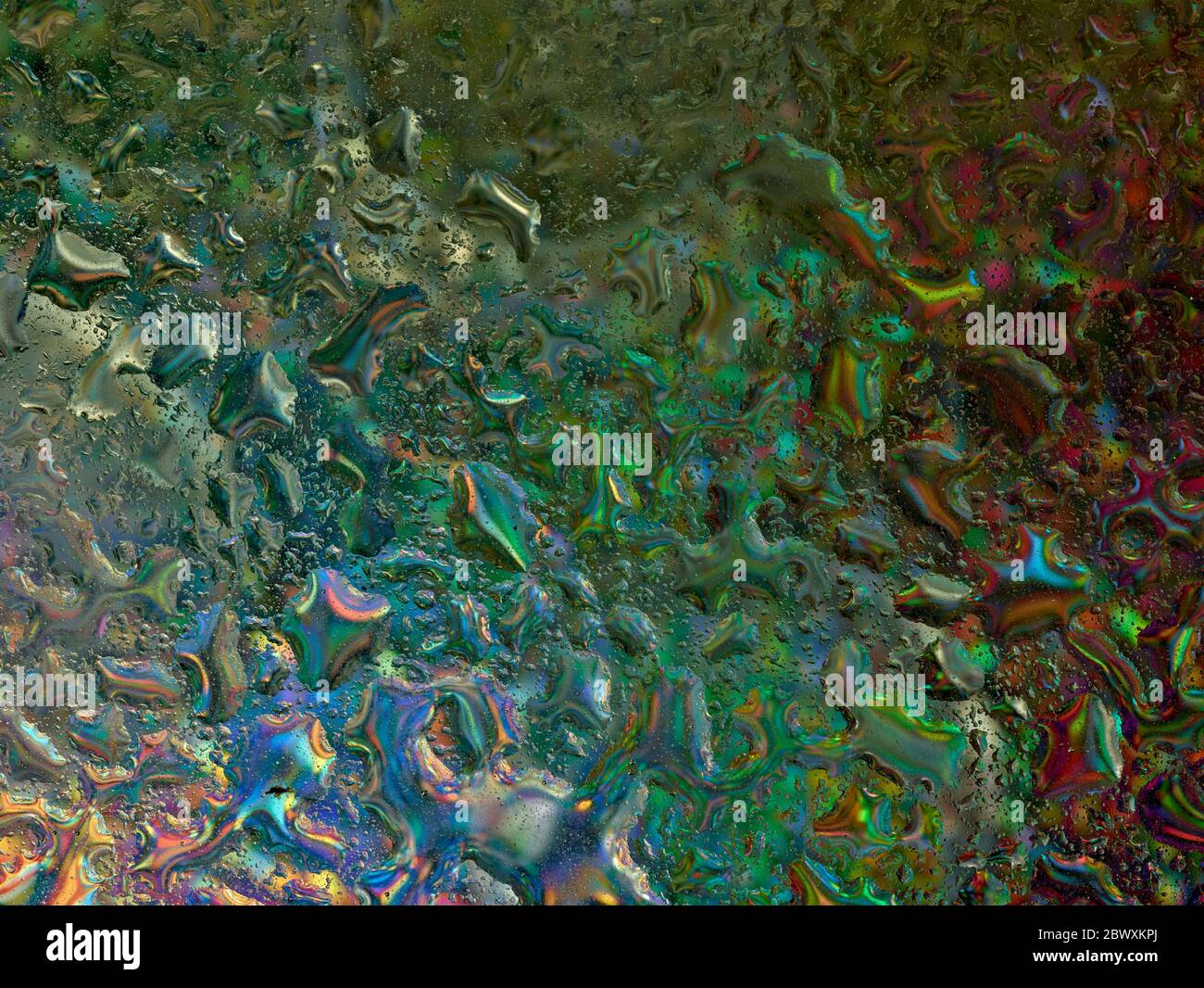 Water drop (drops and droplets) on hard surface with colourful ...