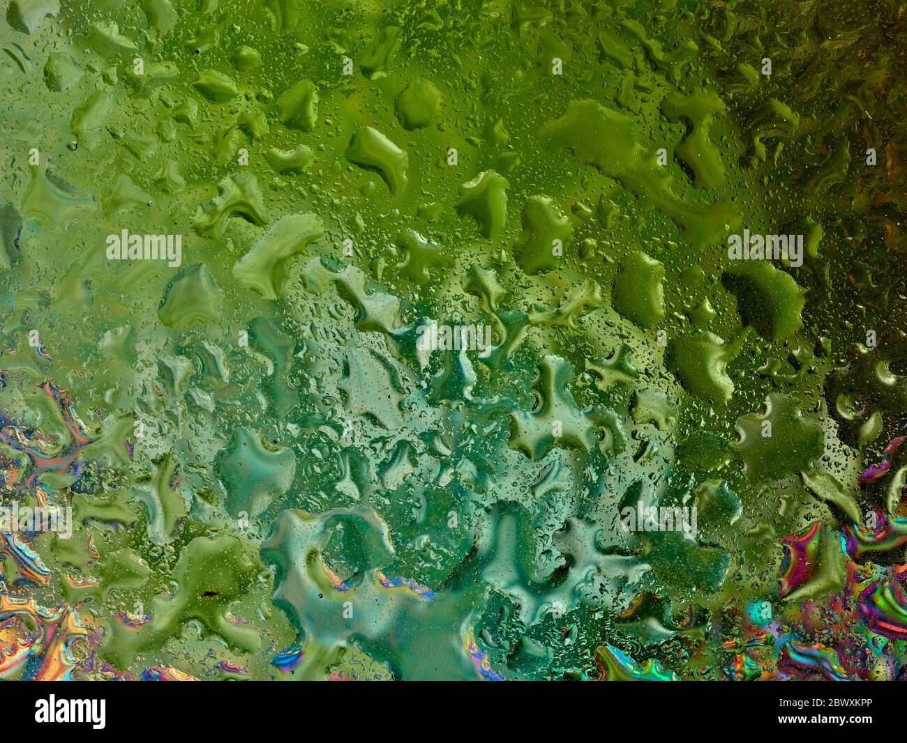 Water drop (drops and droplets) on hard surface with colourful ...