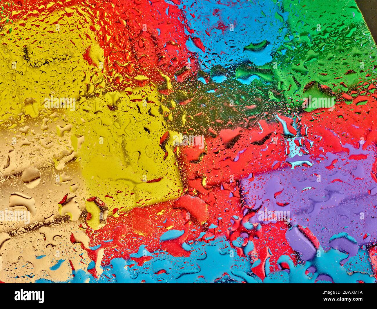 Water drop (drops and droplets) on hard surface with colourful ...
