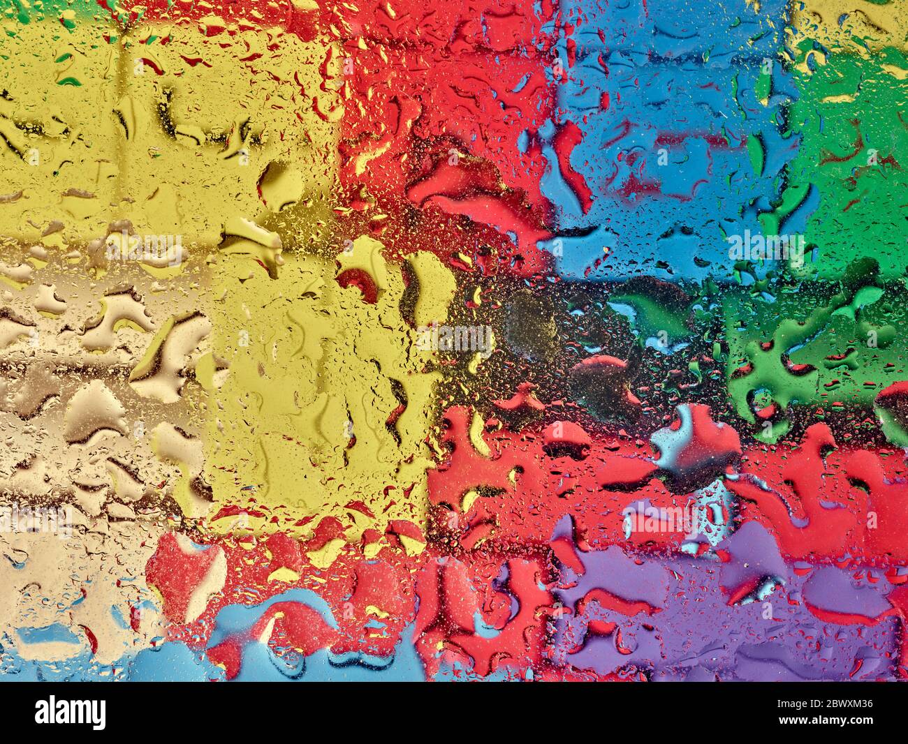 Water drop (drops and droplets) on hard surface with colourful ...