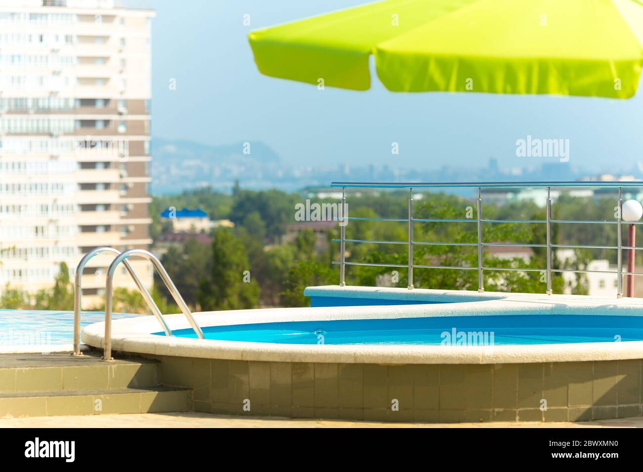 Outdoor swimming pool on beautiful cityscape background luxury scene ...