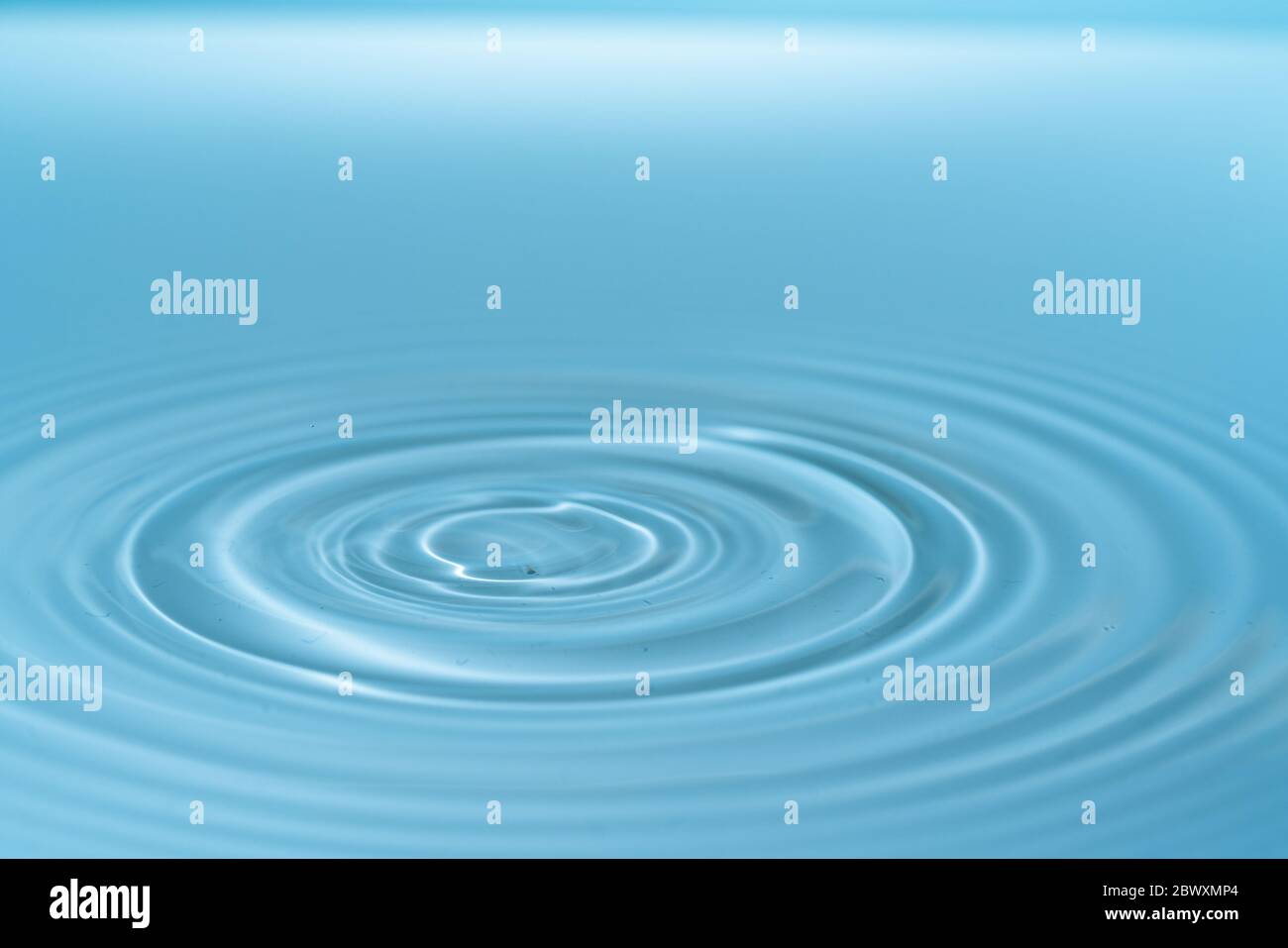 Waves on the surface of the water from a collision. Drop of water drop ...