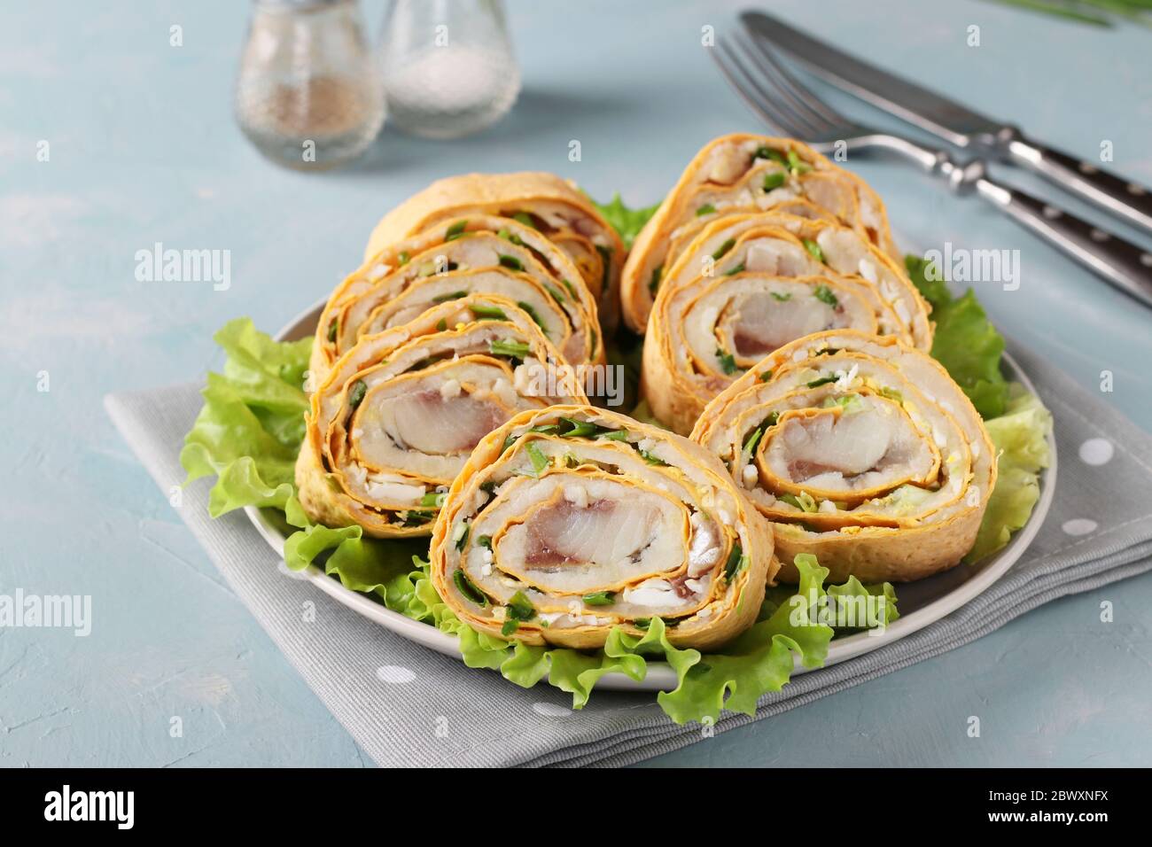 Pita roll with herring, potatoes and onions on light blue background ...