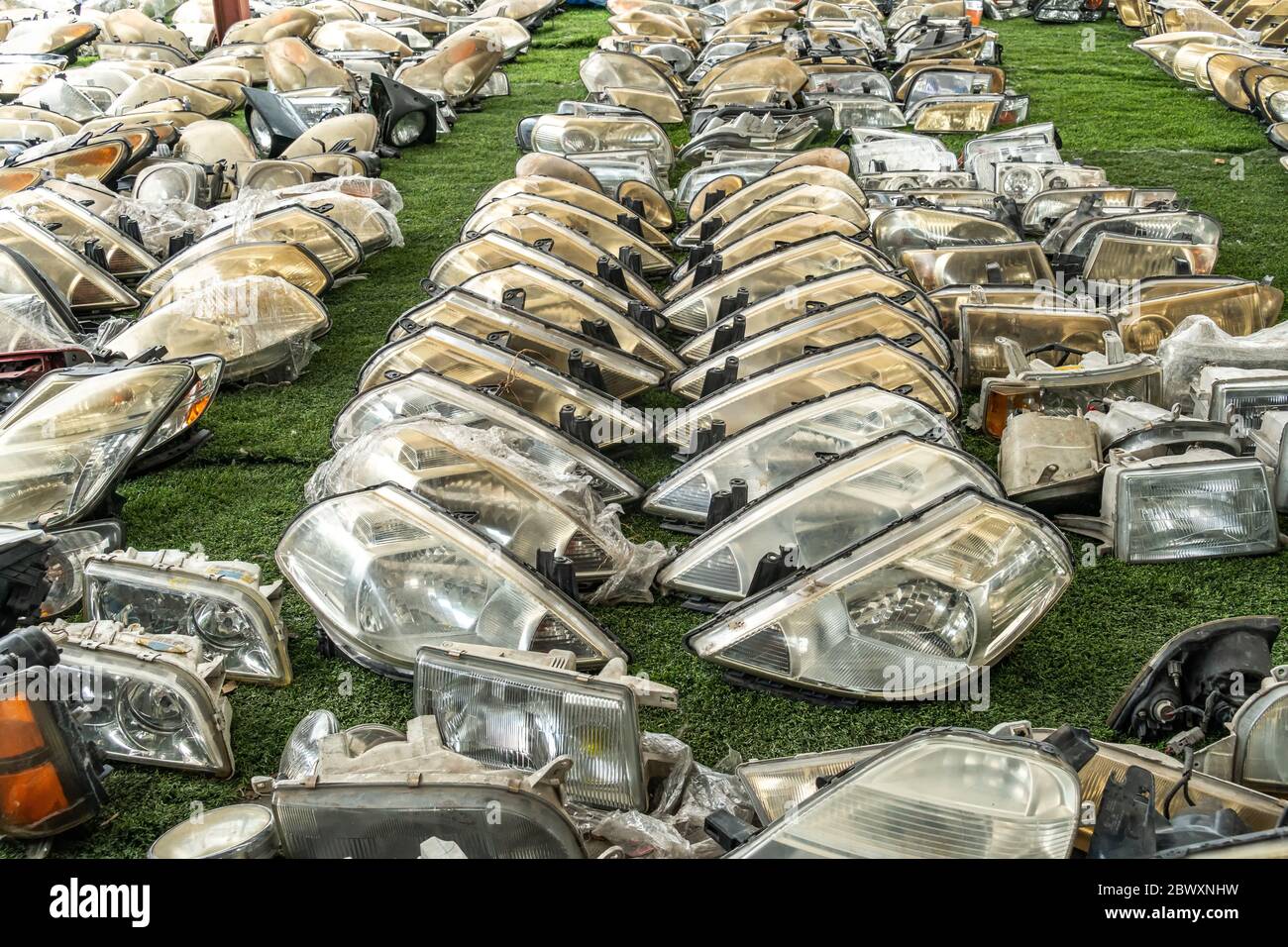 Used headlamp components for sale at scrapyard area Stock Photo - Alamy