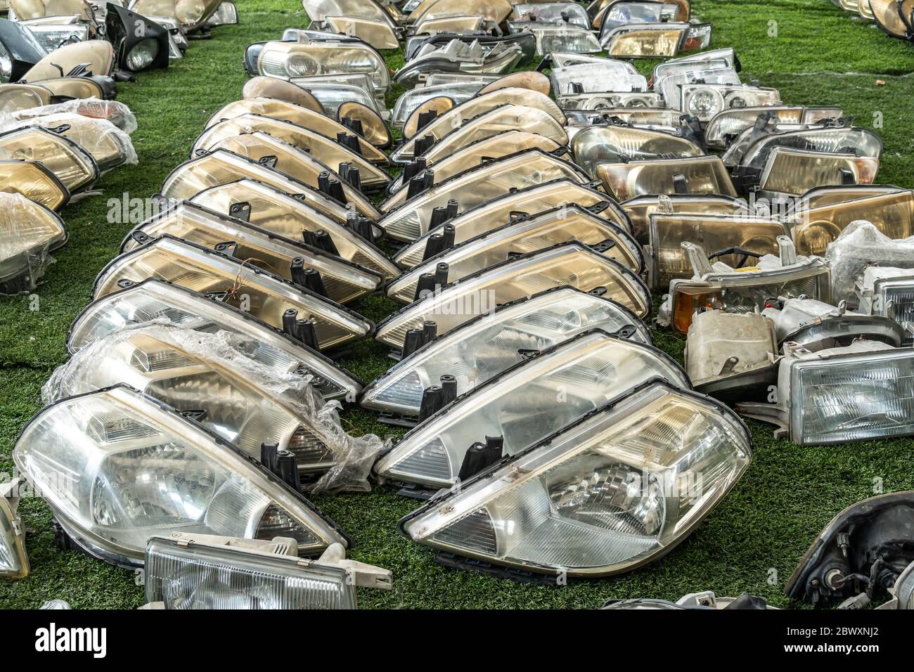 Used headlamp components for sale at scrapyard area Stock Photo - Alamy