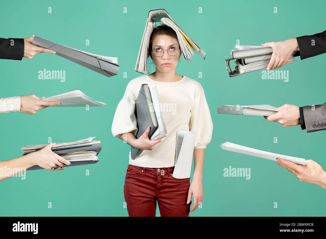 Colleagues and management overload the junior office employee with work ...