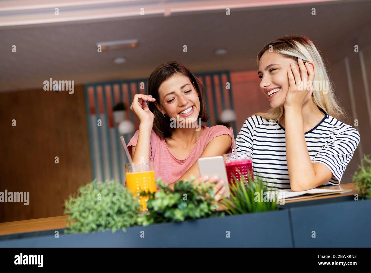 Happy beautiful women friends having fun, talking and smiling Stock ...