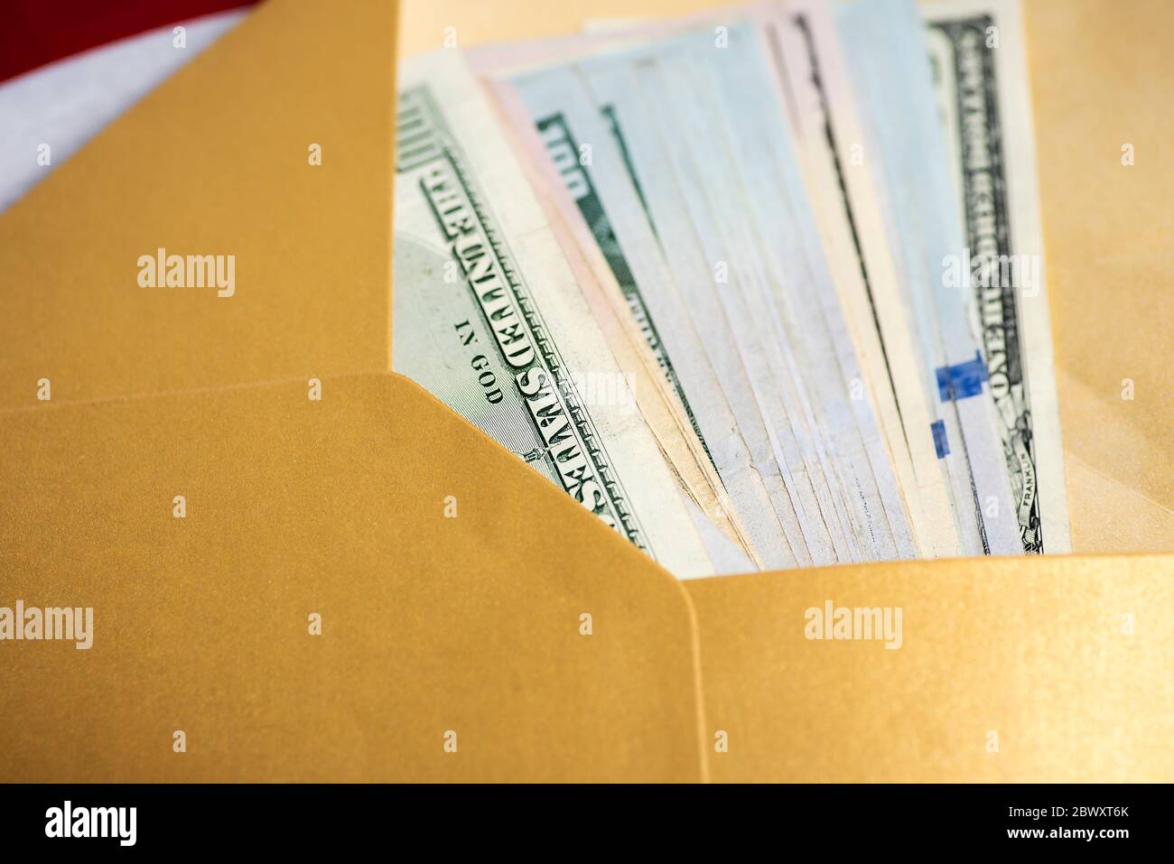 US dollar banknotes in a yellow envelope Stock Photo - Alamy