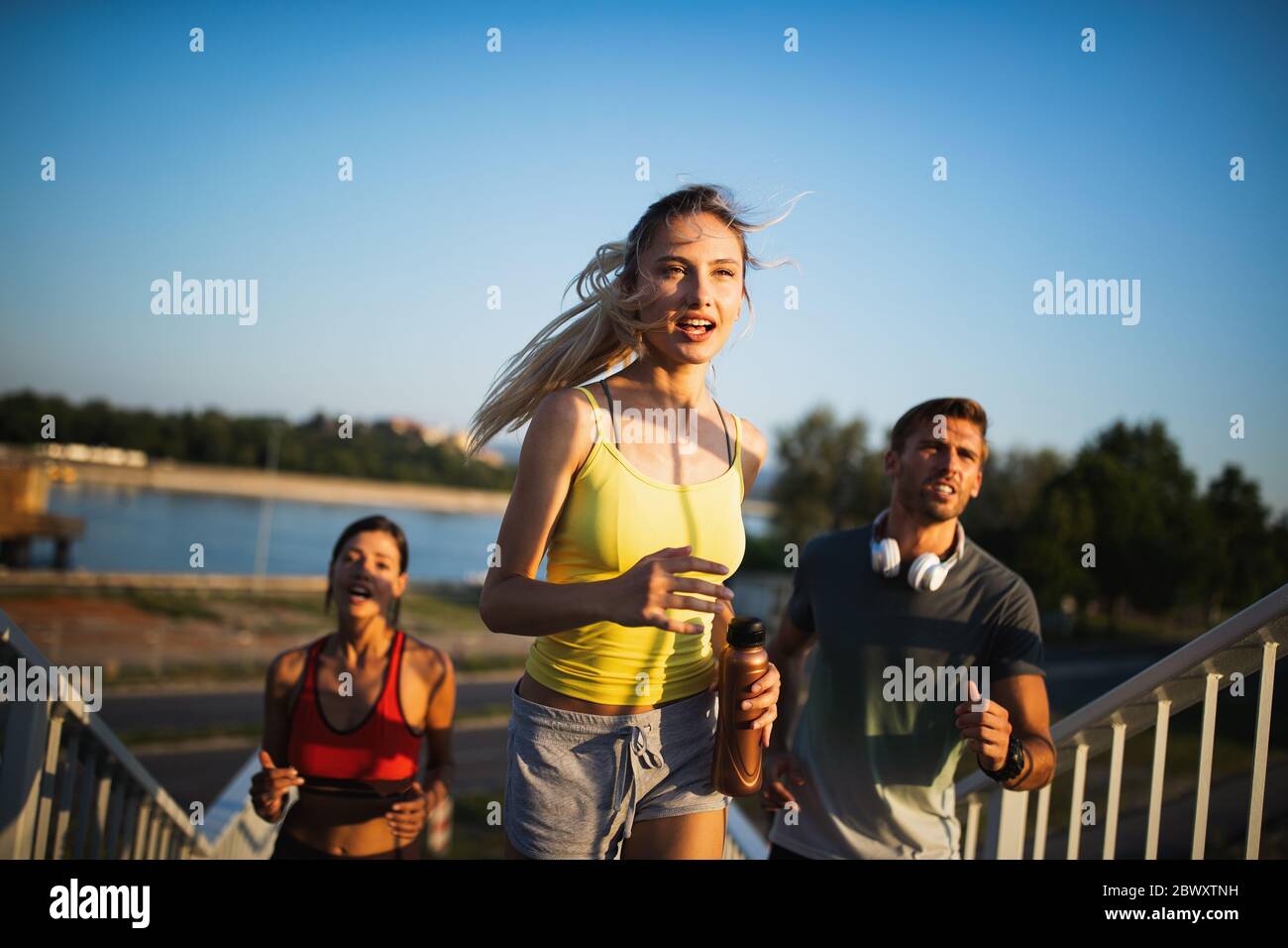 Fitness, sport, people and running concept. Happy fit friends running ...