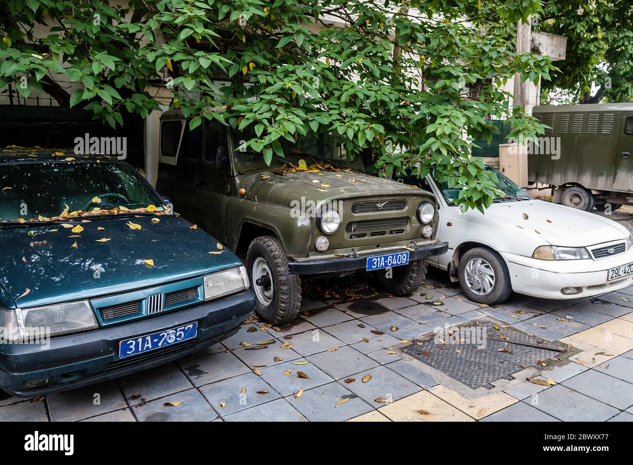 A Soviet-made military SUV UAZ (center) on the city street of Hanoi ...