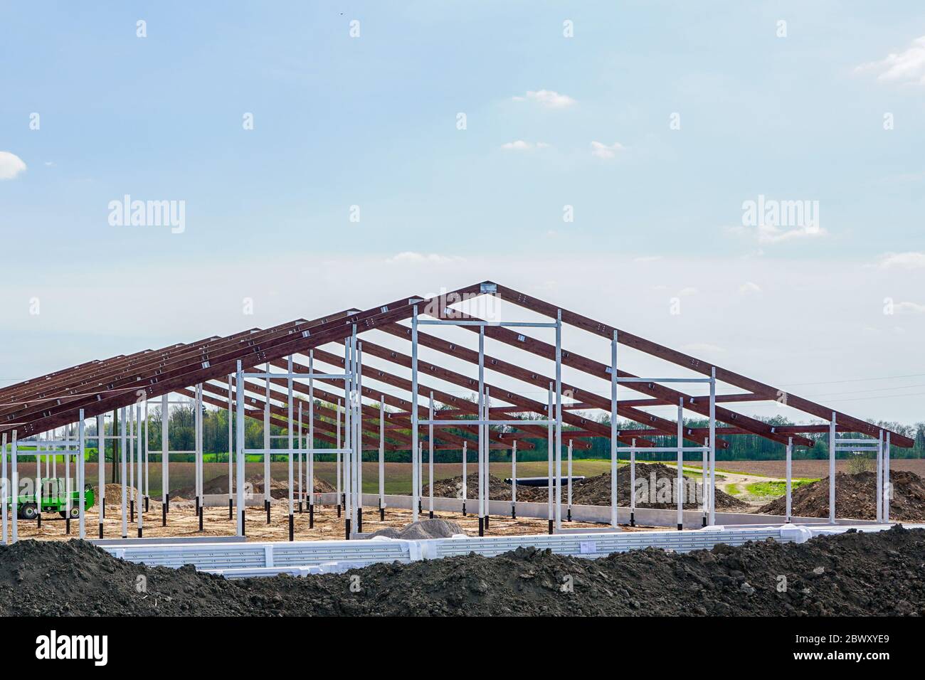 view of a new metal frame structure of an agricultural building under ...