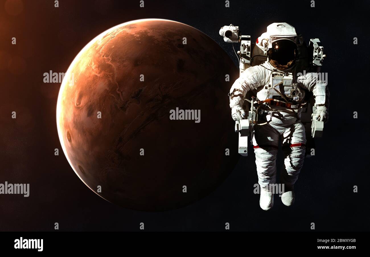 Astronaut and Mars in rays of Sun Stock Photo - Alamy