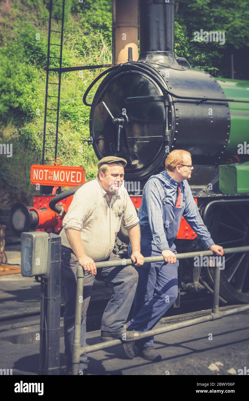 Close up of railway crew workers & steam locomotive in sidings at ...