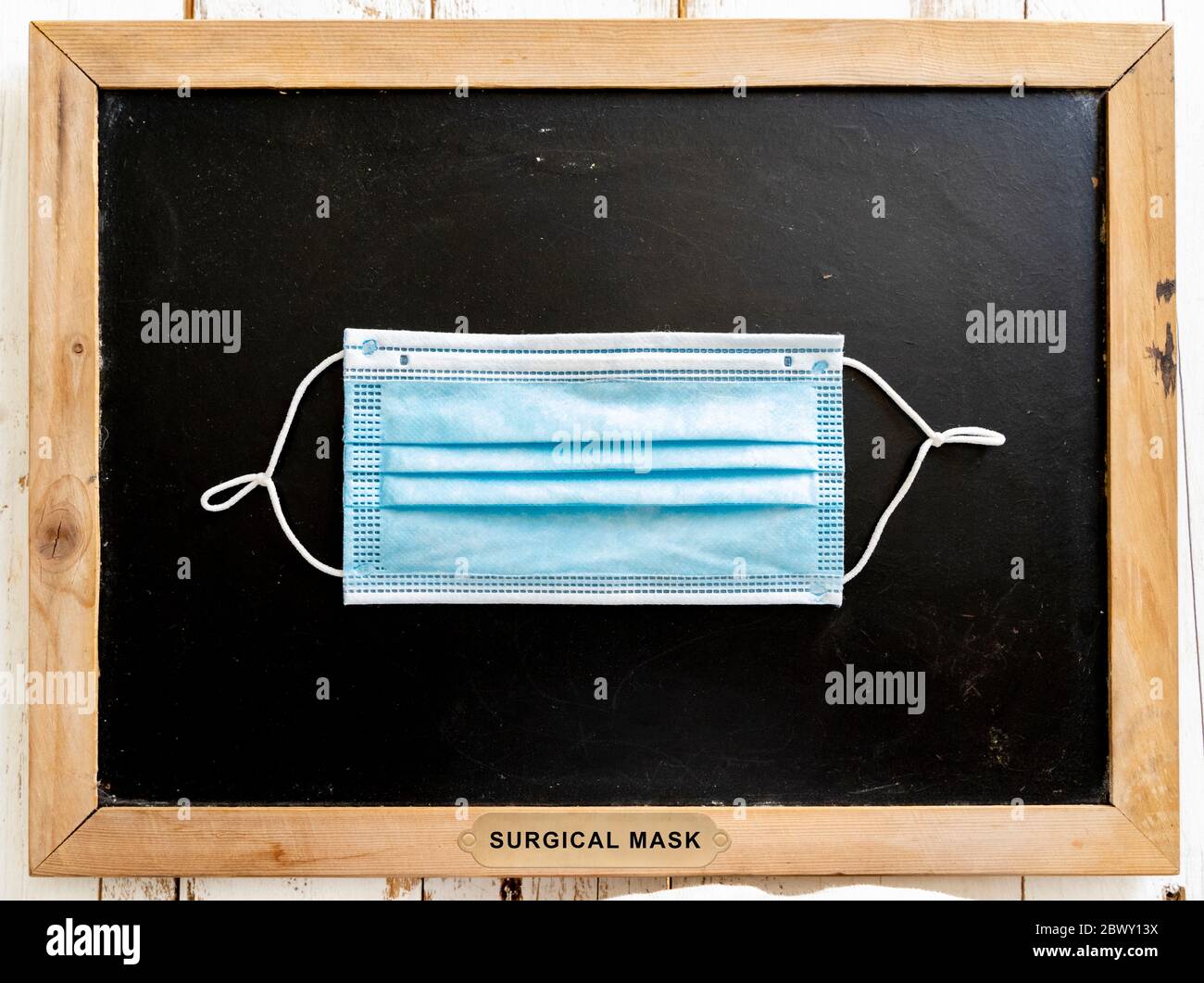 Face mask or surgical mask lays in exhibition on a blackboard ...