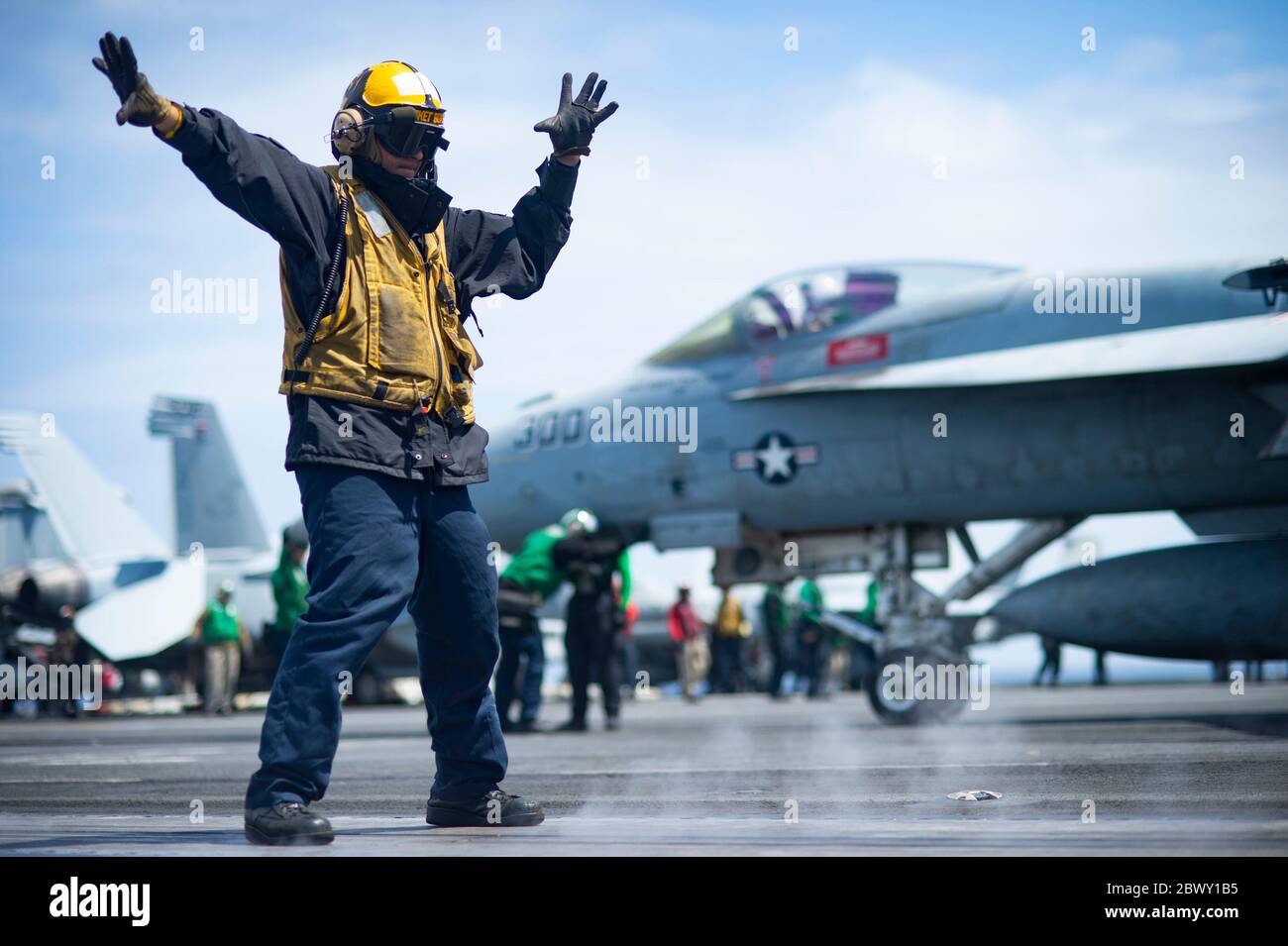 U.S. Navy Aviation Boatswain Mate 3rd Class Dylan Allsopp directs a F/A ...
