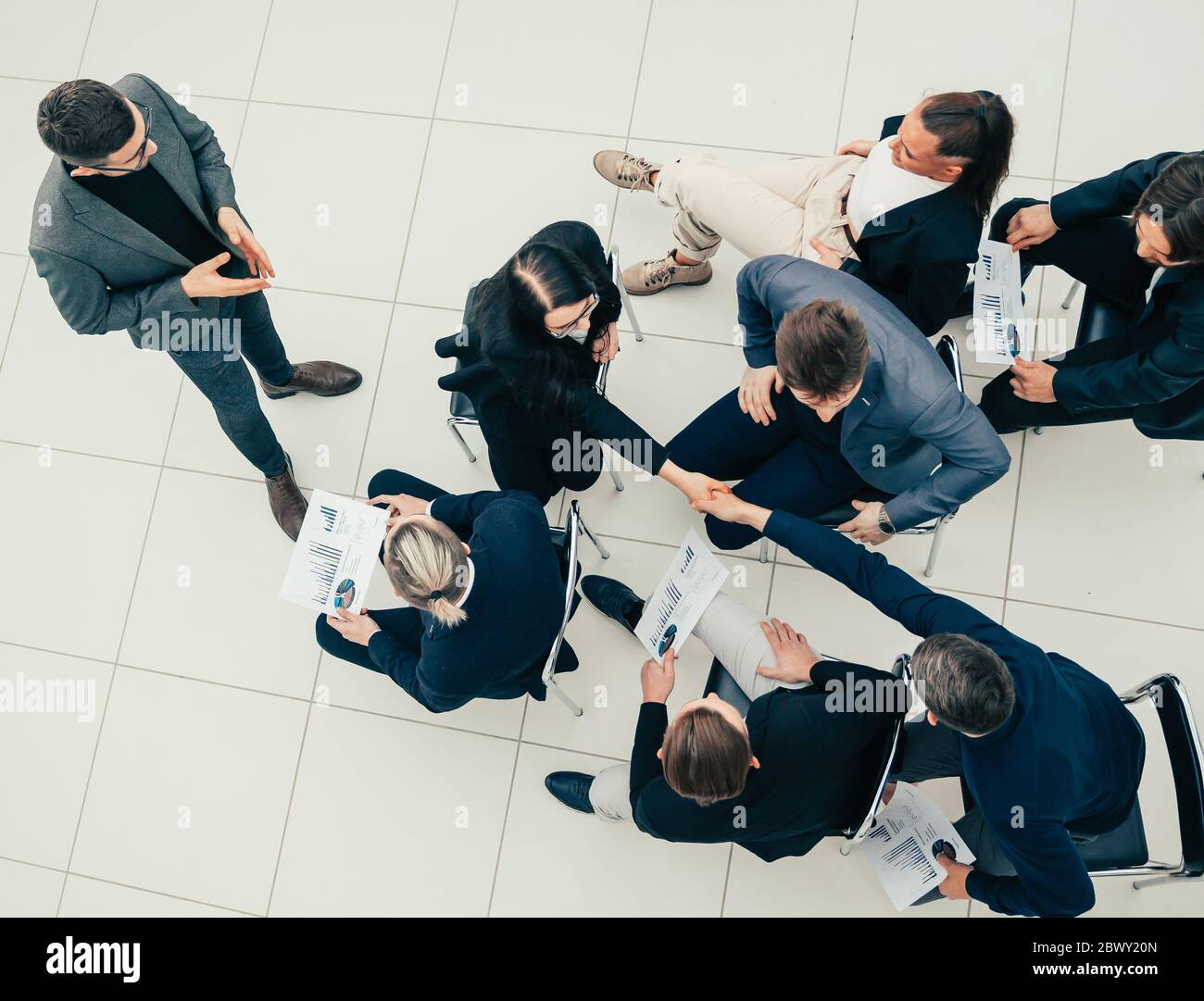 young employees supporting each other with a handshake Stock Photo - Alamy