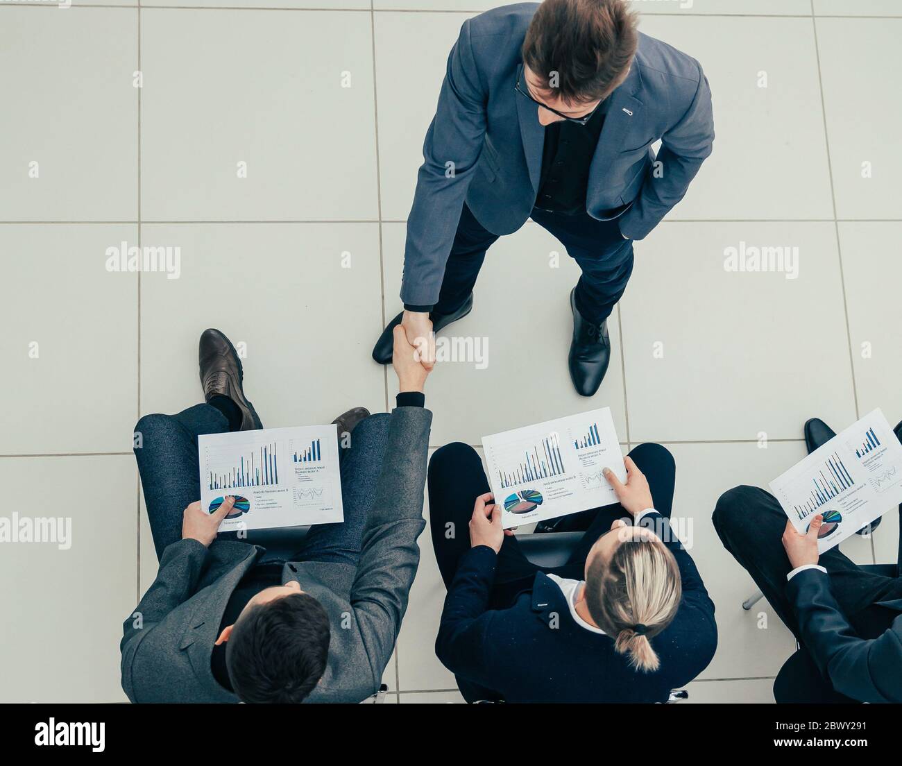 boss shaking hands with an employee during a work meeting Stock Photo ...