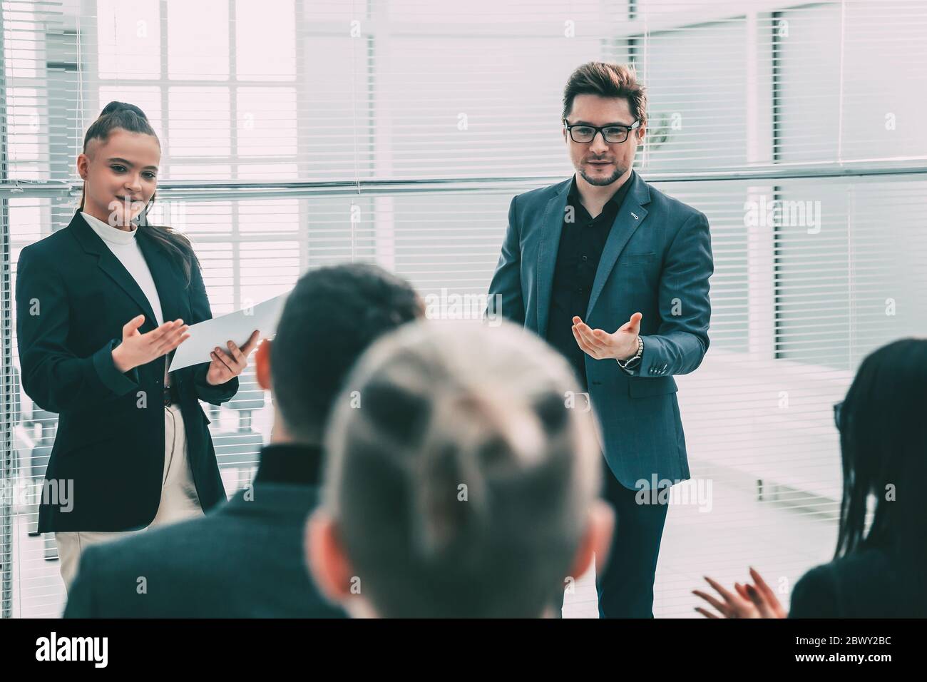 boss congratulating a young employee at a work meeting Stock Photo - Alamy