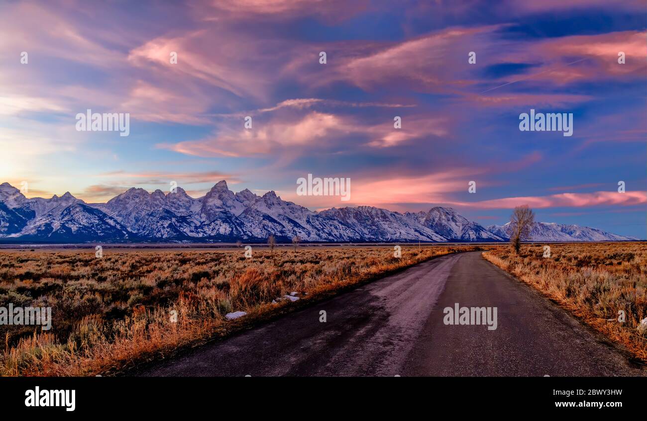 Driving into a Colorful sunrise along US Highway 191 in Jackson Hole ...