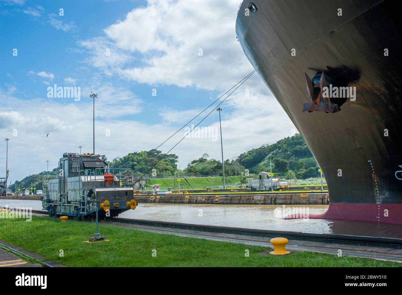 Tug locomotives (mules) towing a container ship through the Panama ...