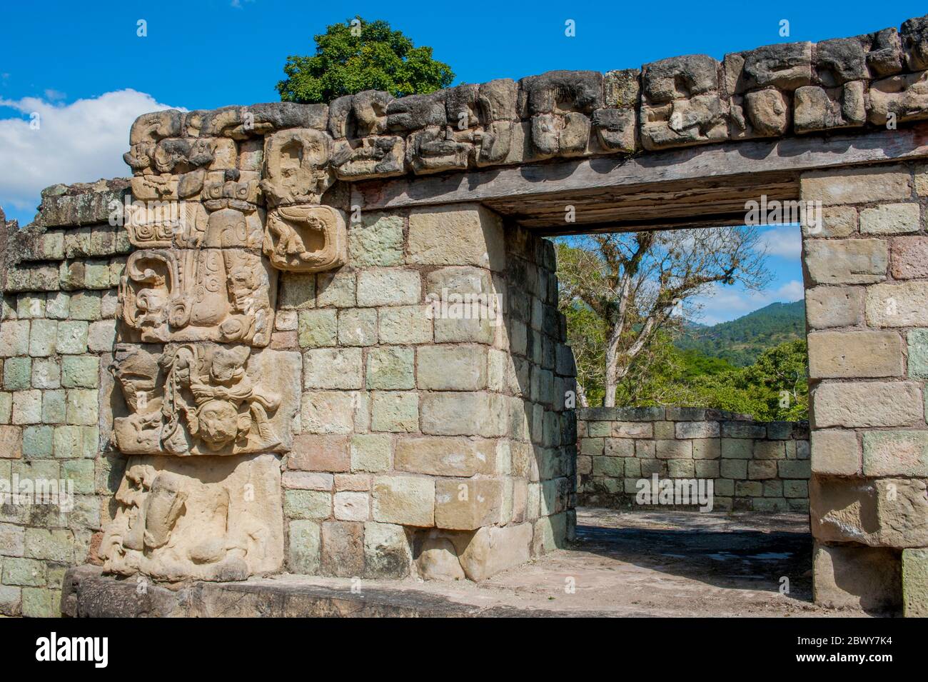 A stone gate with carved skulls at the East Court (Patio Los Jaguares ...