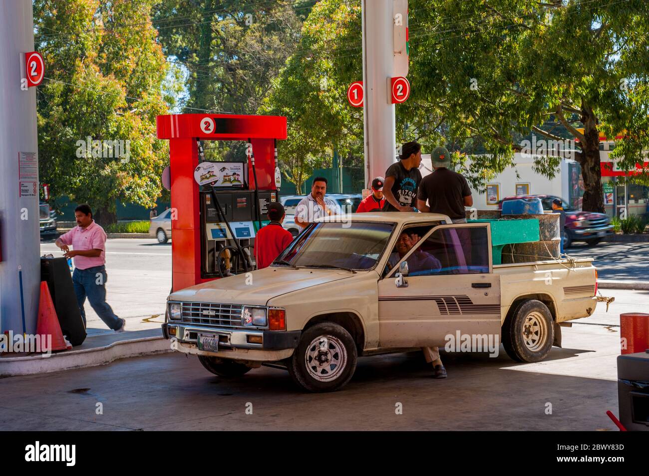 Cars getting gasoline at a gas station in Guatemala City in Guatemala ...