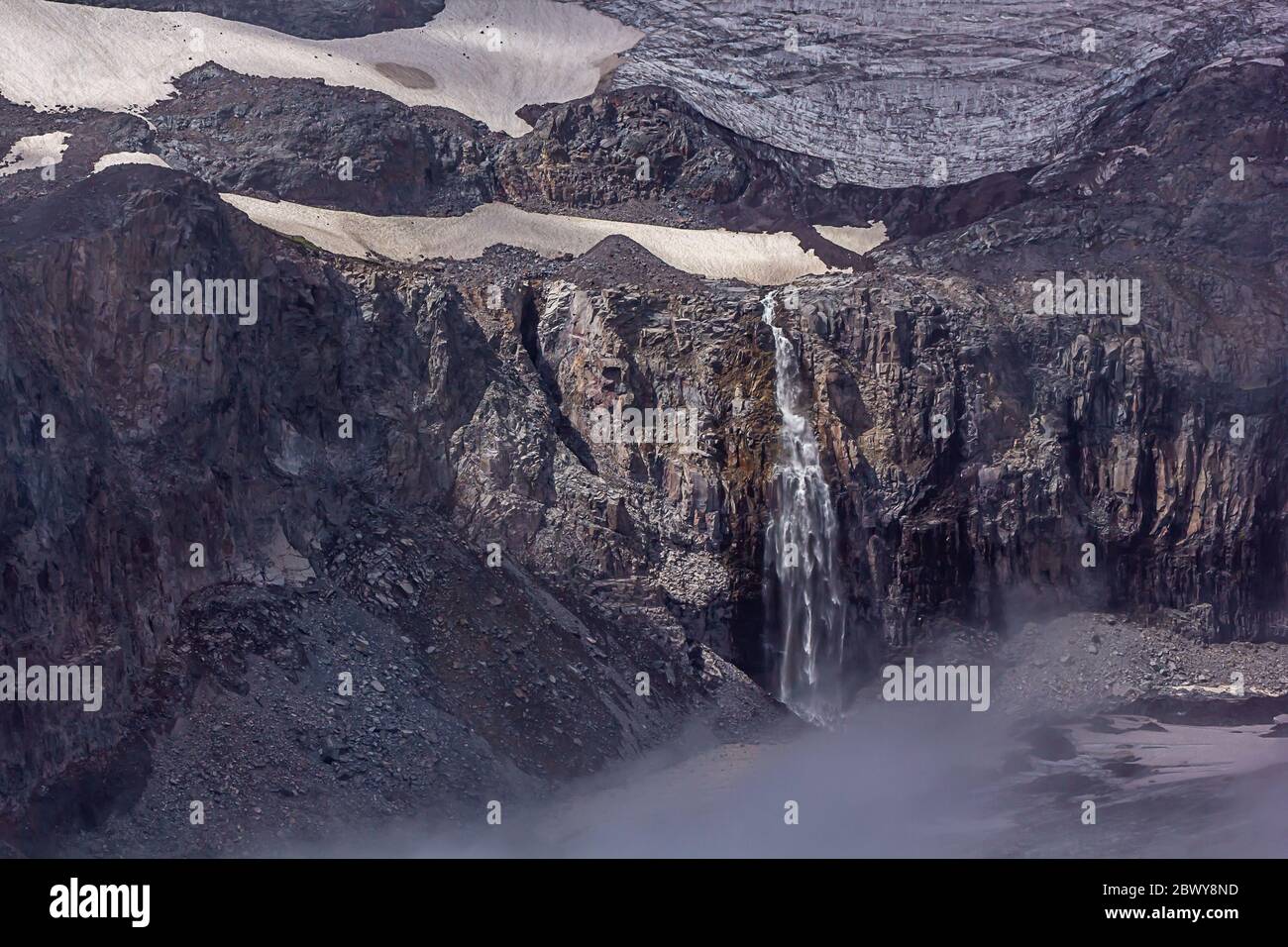 clear clean waterfall from glacialmelt in harsh landscape with valley ...
