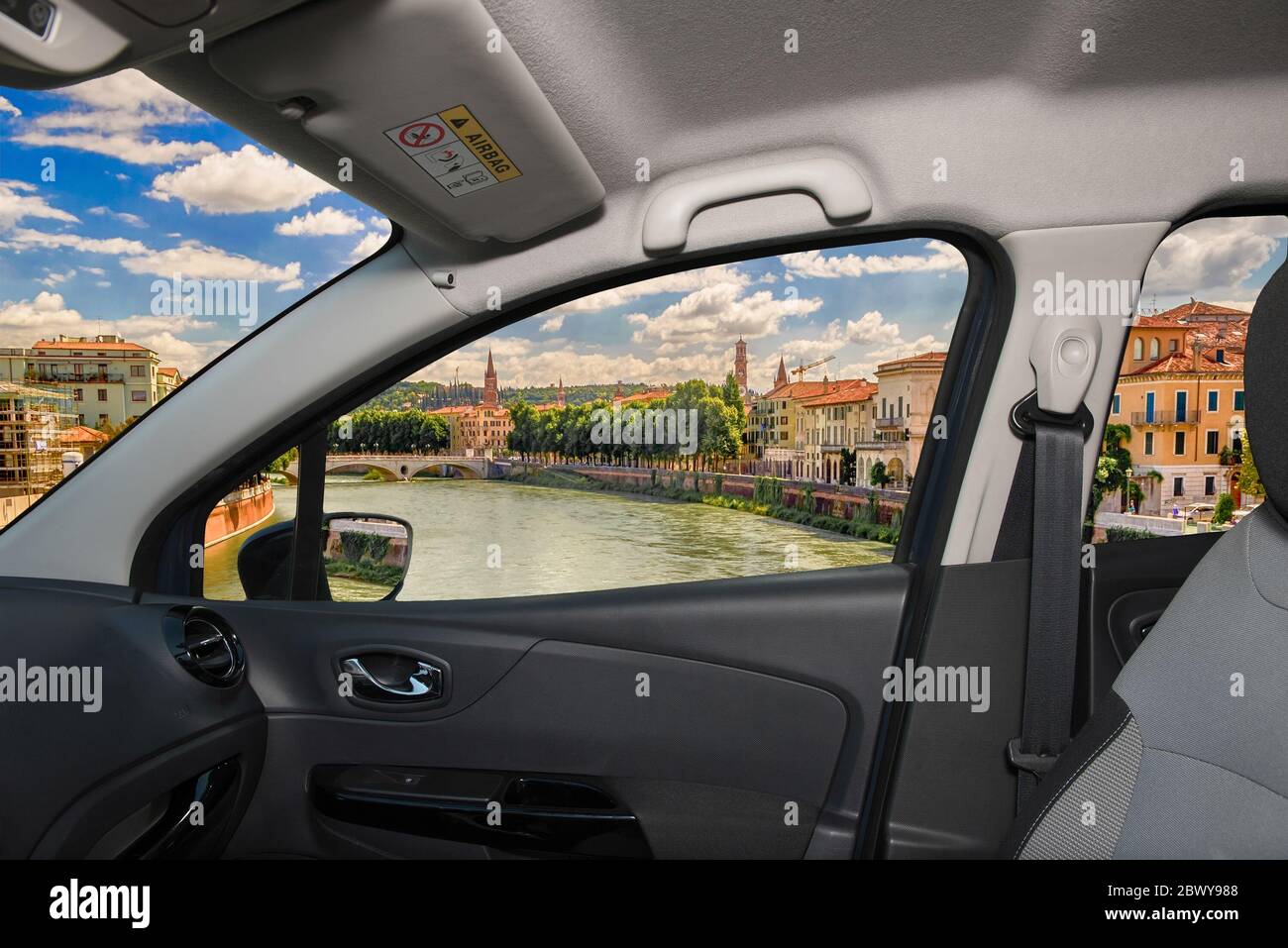 Looking through a car window with view over Adige River in central ...