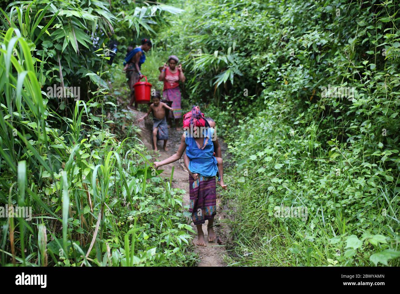 Indigenous people make their way through the jungle at Thanchi in ...
