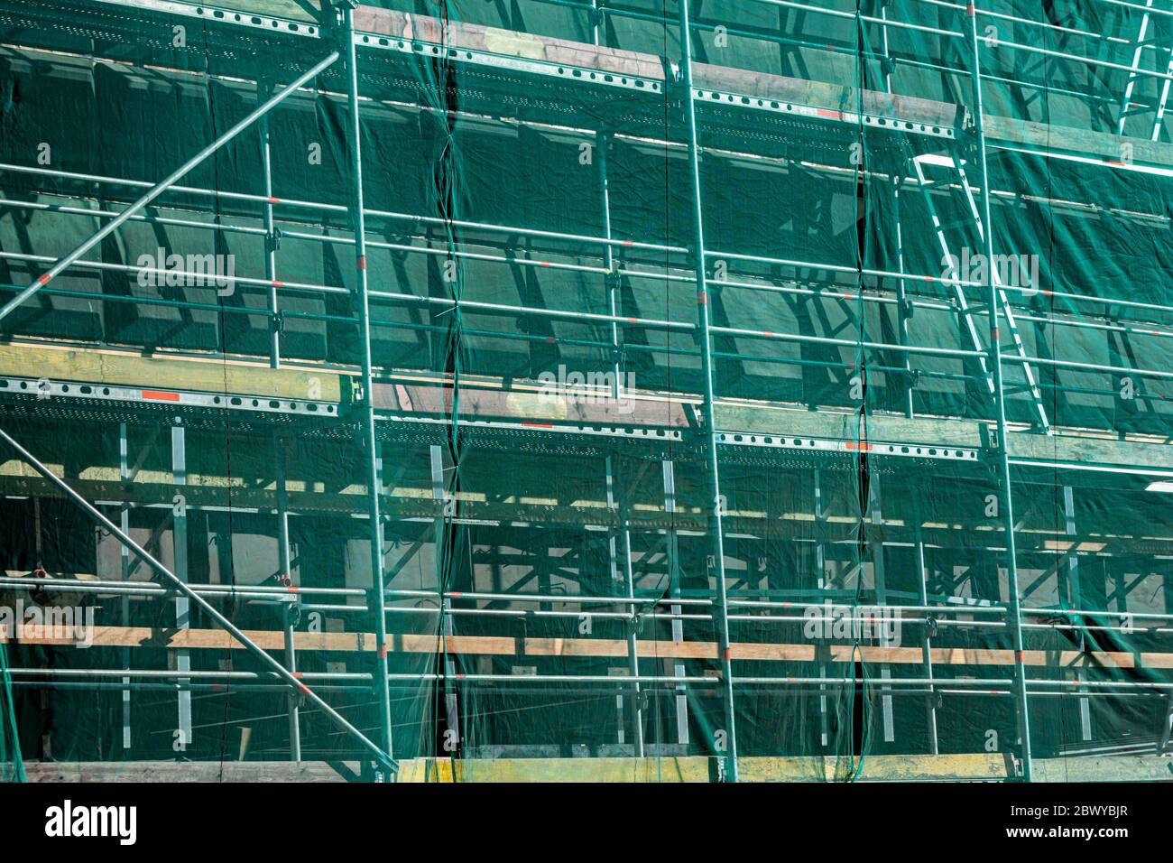 scaffolding covered in green mesh. Construction or repair work ...