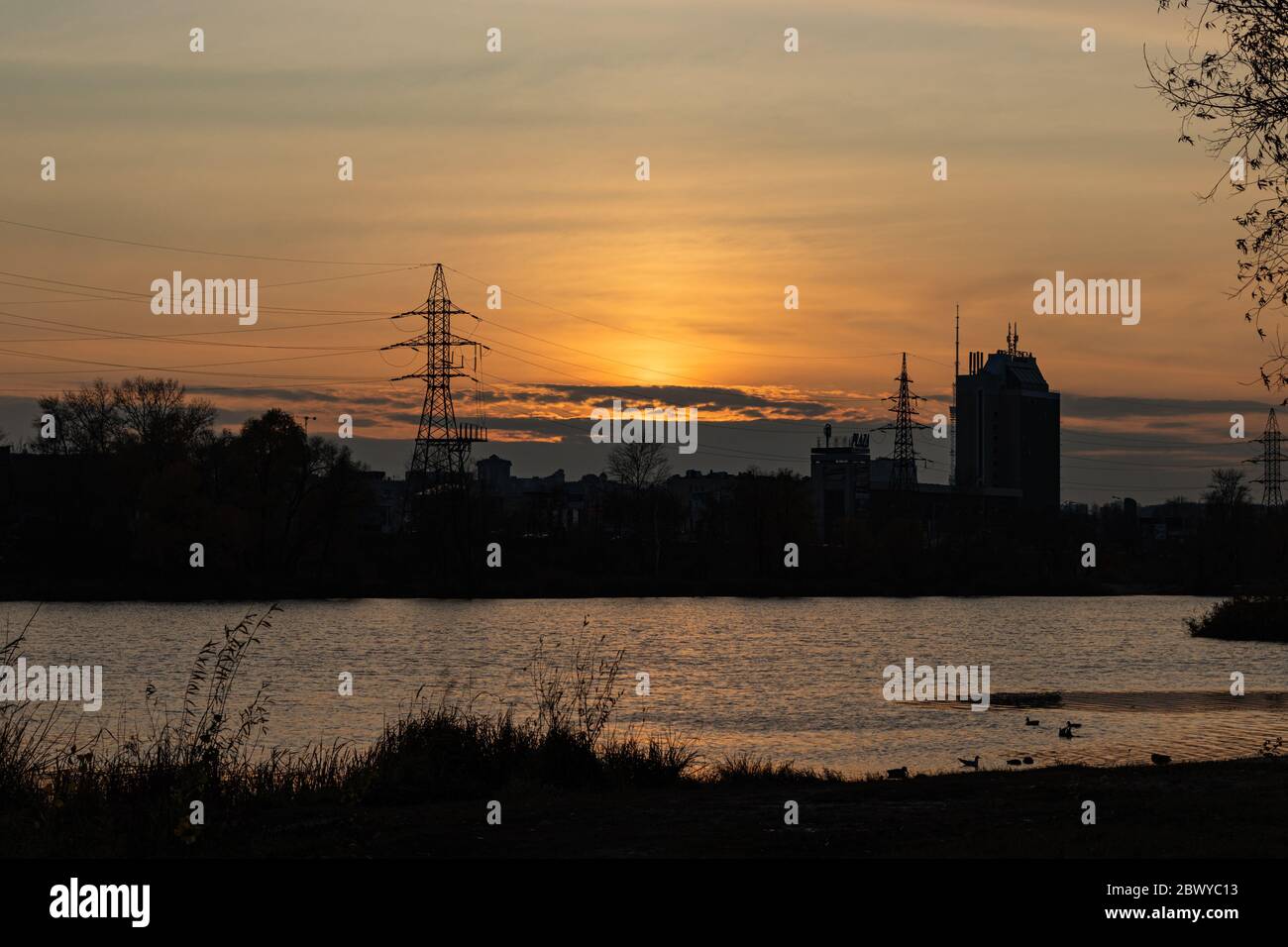 Kyiv sunset landscape with a lake and buildings. Dusk Stock Photo - Alamy