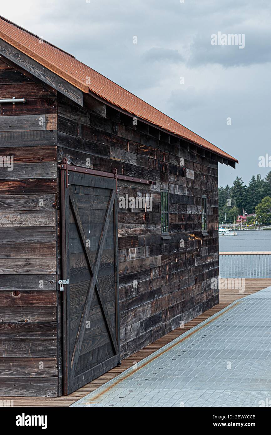 large sliding barn doors built with dark reclaimed wood Stock Photo - Alamy