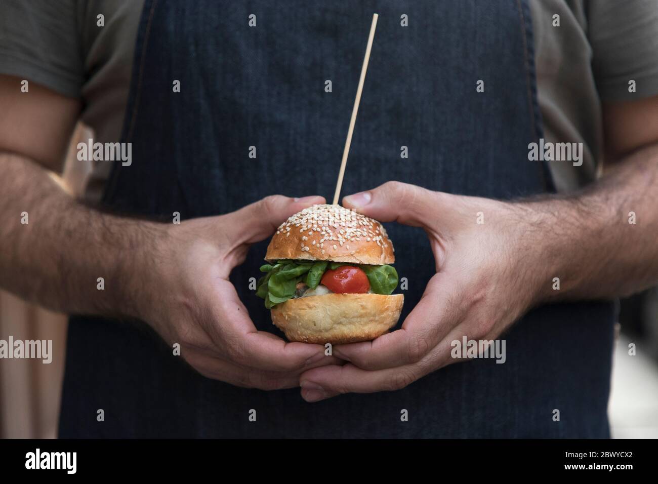 Handheld burger hi-res stock photography and images - Alamy