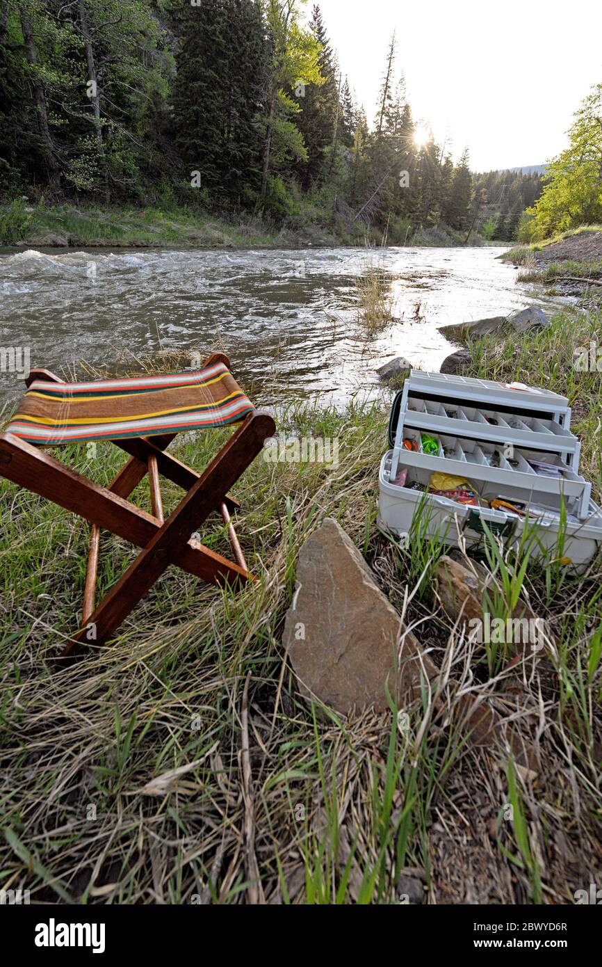 Fishing tackle box and stool on the Crowsnest River. Alberta Canada ...