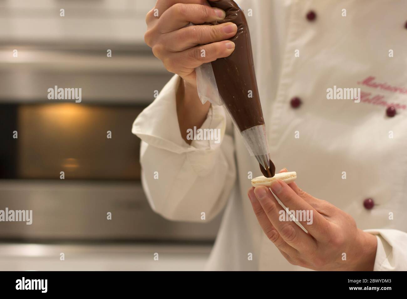 Detail of the preparation of macaron, french sweet food, inside a ...