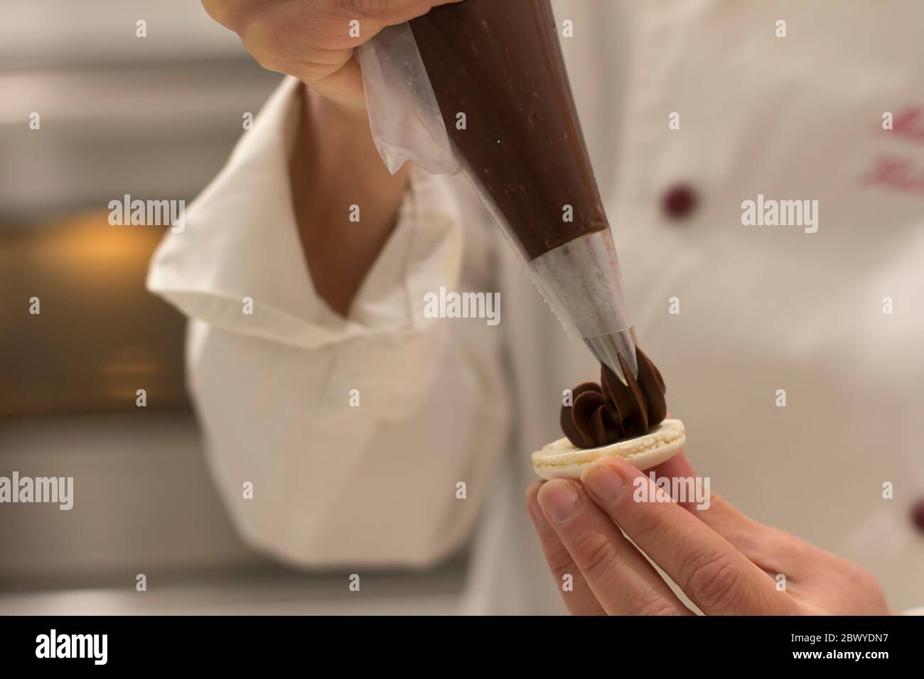 Detail of the preparation of macaron, french sweet food, inside a ...