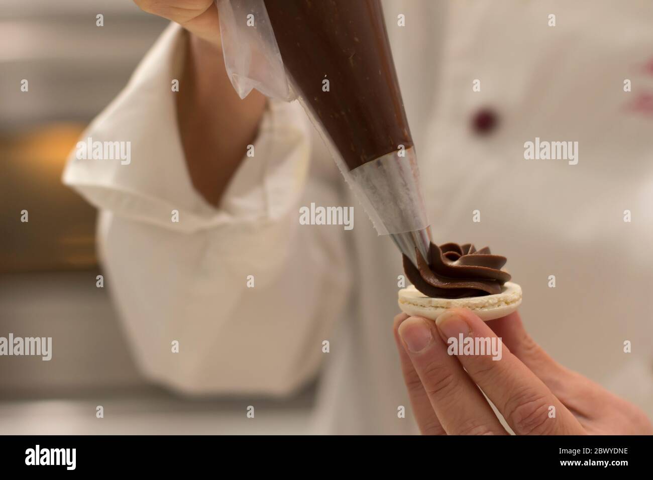 Detail of the preparation of macaron, french sweet food, inside a ...