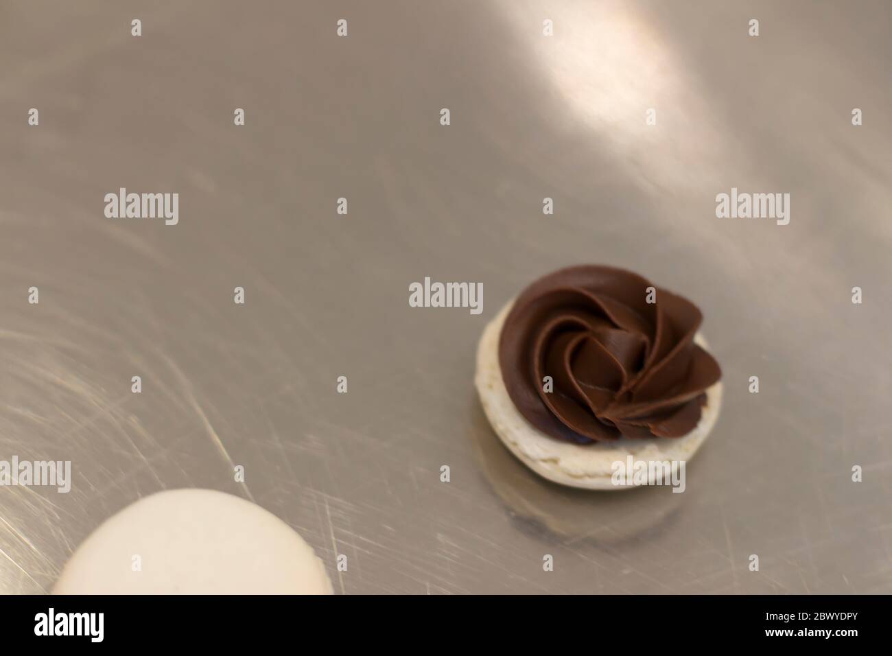 Detail of the preparation of macaron, french sweet food, inside a ...