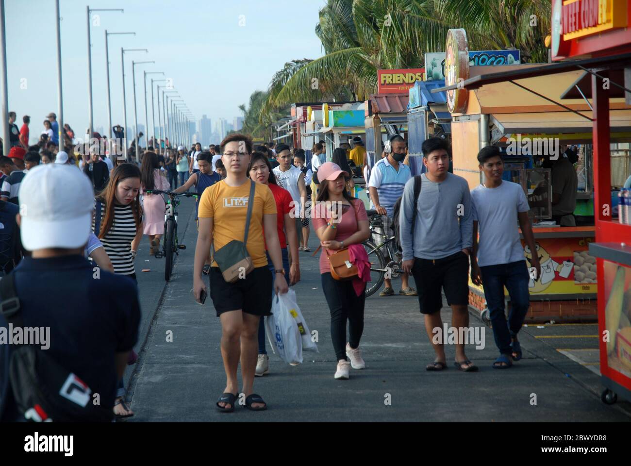Crowds gather along seaside walk, Mall of Asia, Pasay City, Manila ...