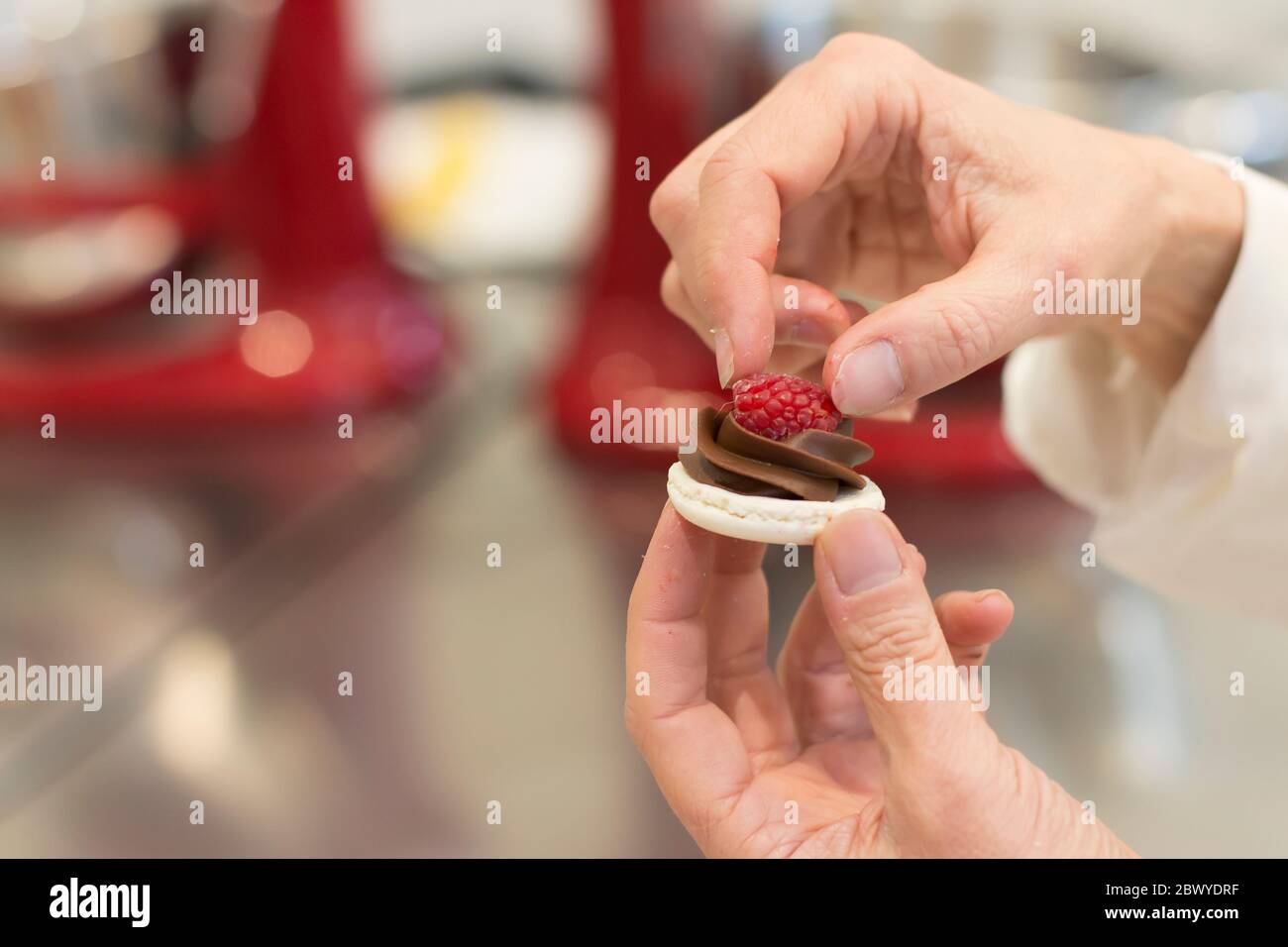 Detail of the preparation of macaron, french sweet food, inside a ...