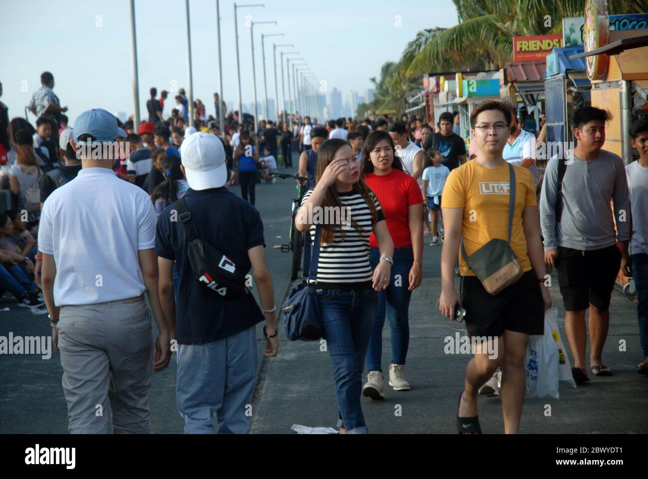 Crowds gather along seaside walk, Mall of Asia, Pasay City, Manila ...