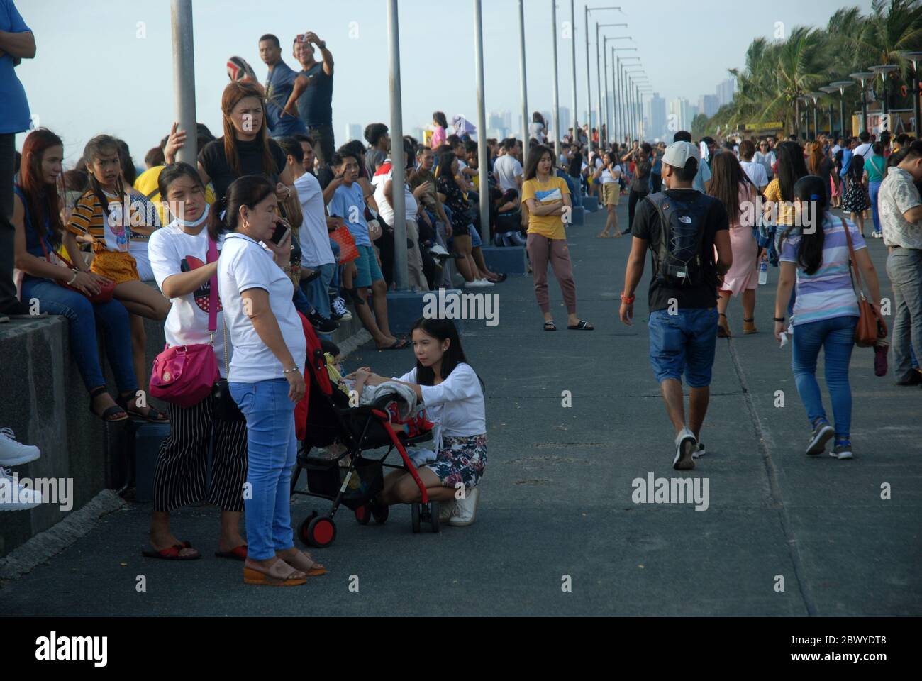 Crowds gather along seaside walk, Mall of Asia, Pasay City, Manila ...