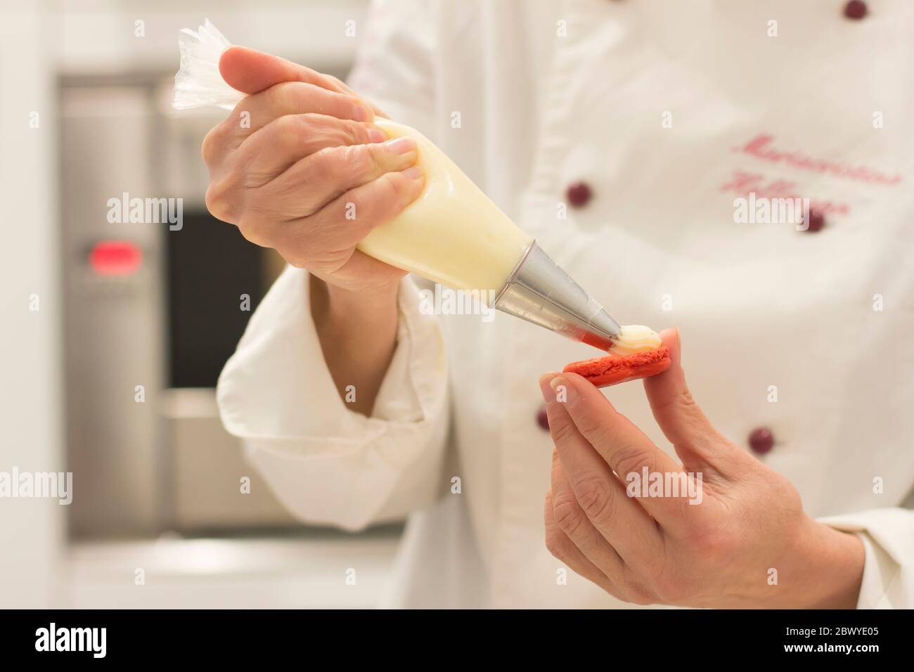 Detail of the preparation of macaron, french sweet food, inside a ...