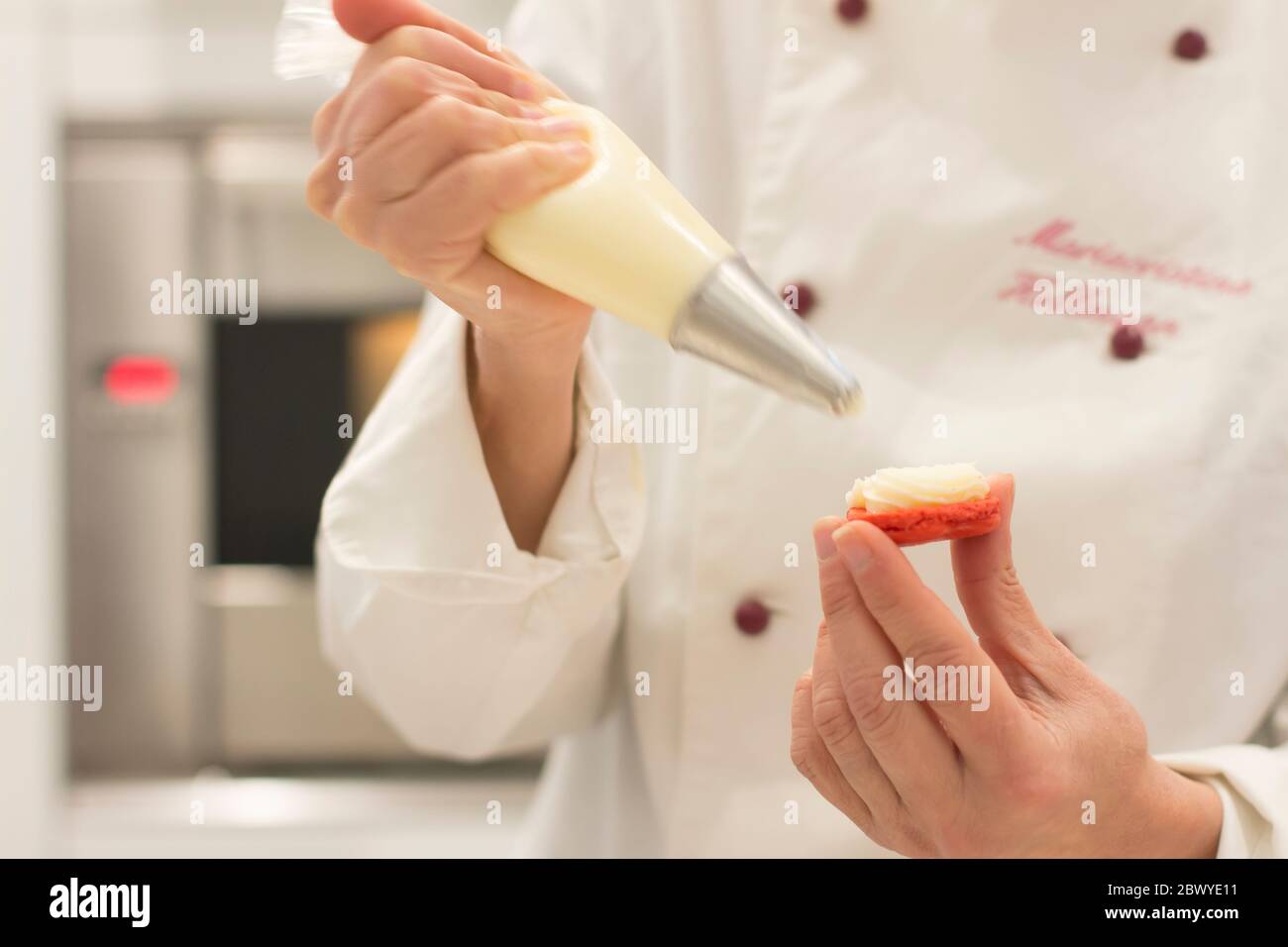 Detail of the preparation of macaron, french sweet food, inside a ...